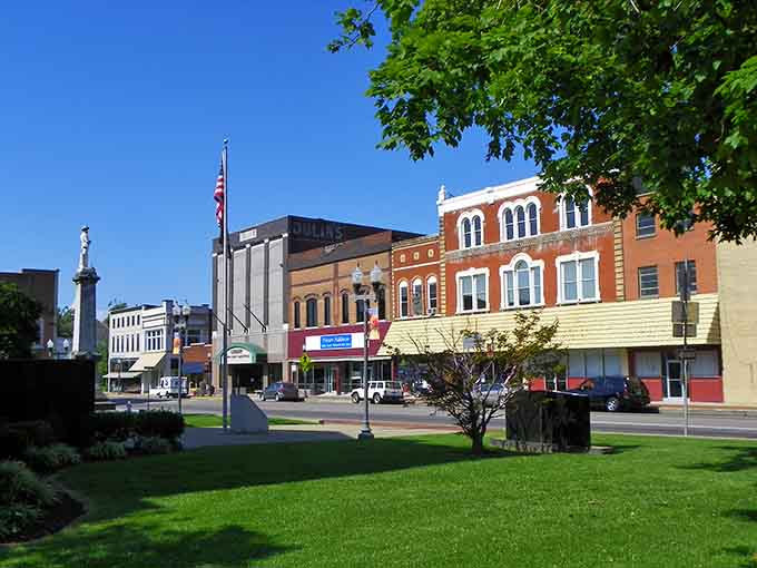 Madisonville's town square combines monument, greenery, and historic storefronts in one perfectly composed slice of Americana.