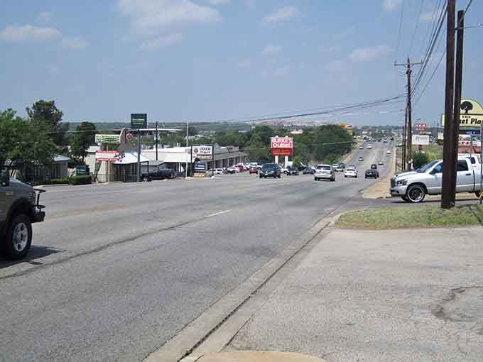 The road stretches toward distant hills, inviting you to slow down and savor the journey ahead.