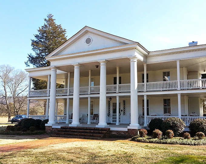 This grand columned building in Mentone exudes Southern elegance, its white pillars and wraparound porch inviting visitors to sit and stay awhile.