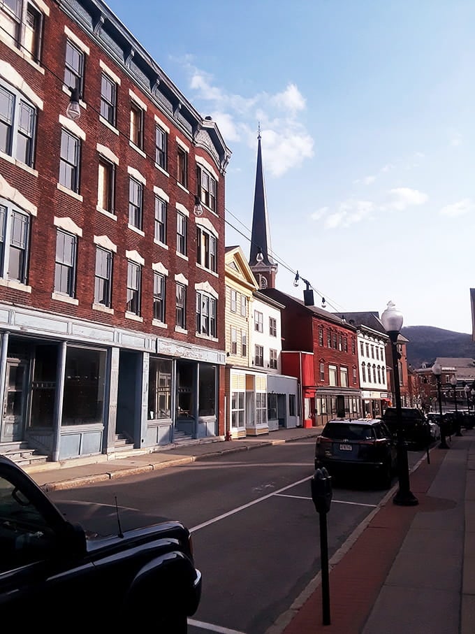 Colorful buildings pop against mountain backdrops, creating a scene that belongs on a vintage postcard.