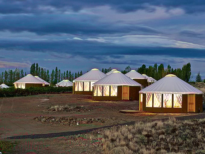 Those glowing yurts at twilight look like something from another continent decided to vacation in Washington permanently.