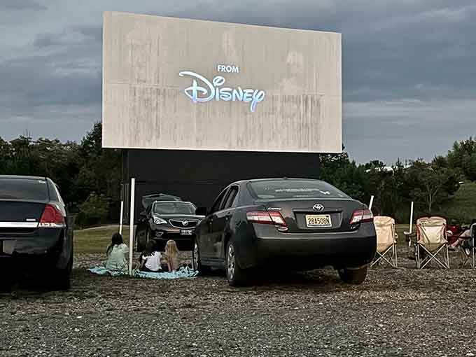 When Disney lights up the drive-in screen, three generations suddenly remember why this tradition never gets old.