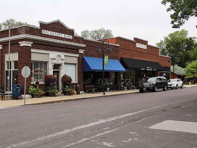 The old bank building anchors this main street where blue awnings shade shops that remember when handshakes sealed deals.