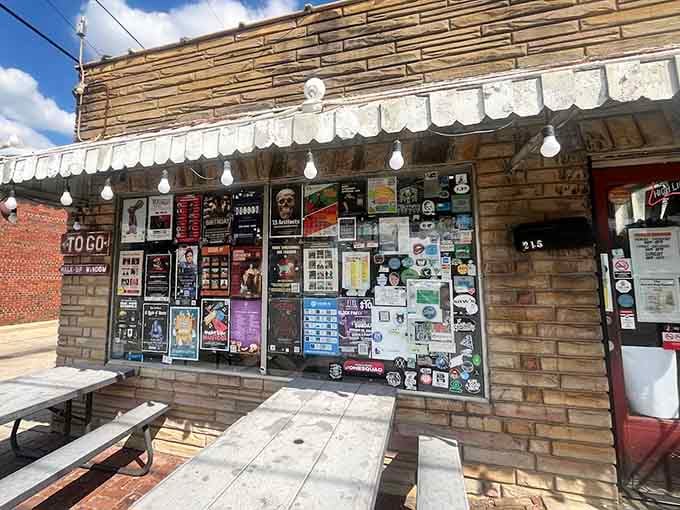 Every inch of this storefront tells a story, covered in flyers and memories like a beloved community bulletin board.