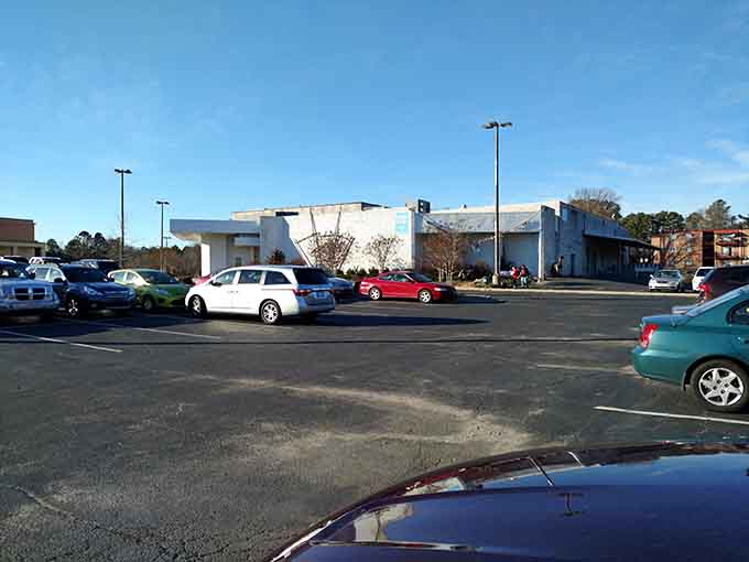 The industrial-chic exterior with autumn trees signals a creative reuse center where imagination runs wild.