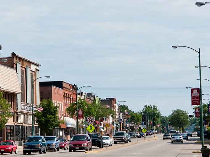Tree-lined streets frame historic buildings where locals still shop and neighbors still wave to passing cars.