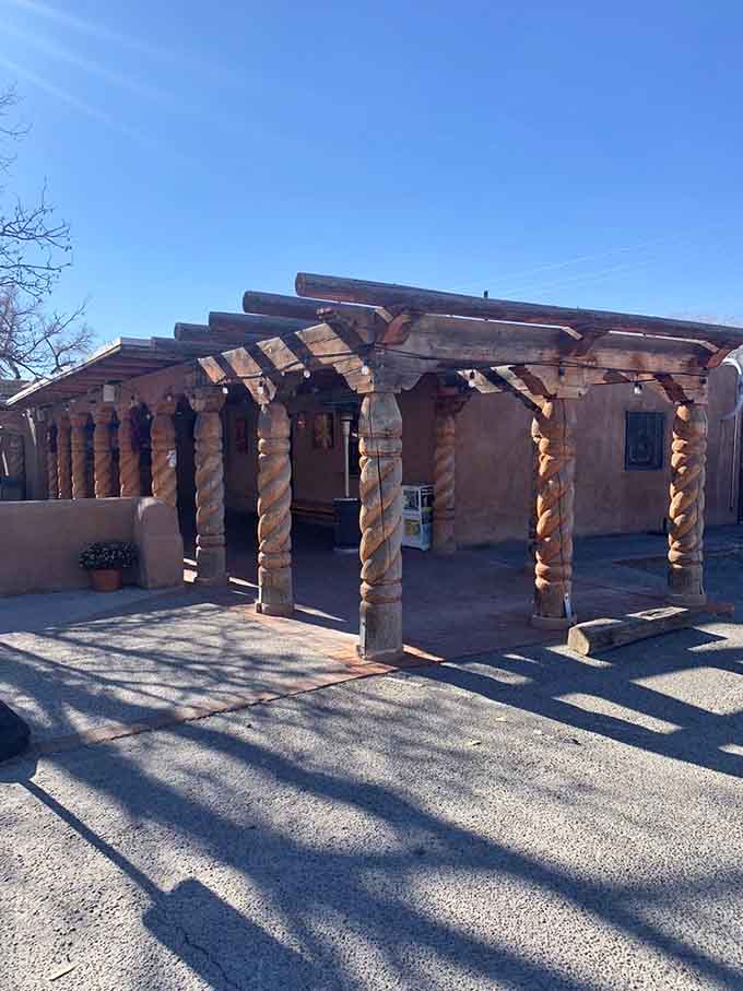 Wooden beams and pueblo-style charm create the perfect backdrop for artisan pizza perfection.