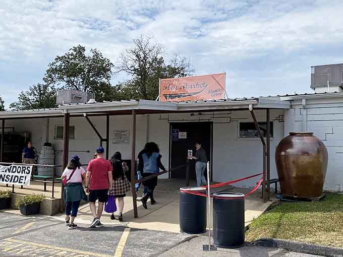 Families stream through the entrance, eager to explore outdoor vendor stalls brimming with everything from tools to trinkets.