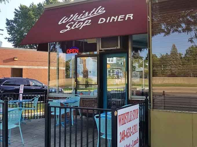 Whistle Stop's charming red awning and outdoor seating create the perfect setting for people-watching over coffee.