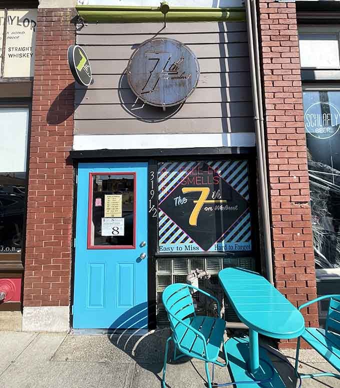 That bright turquoise door pops against the brick like a cheerful invitation to discover what delicious surprises hide in this tiny space.