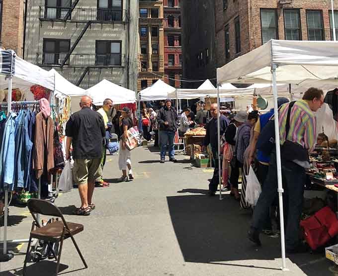 Tent after tent stretches down the pavement, creating a maze of vintage clothing and collectible finds.