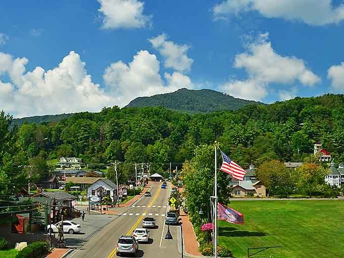 The road winds through this picturesque valley town, with Grandfather Mountain's watchful presence looming in the background.