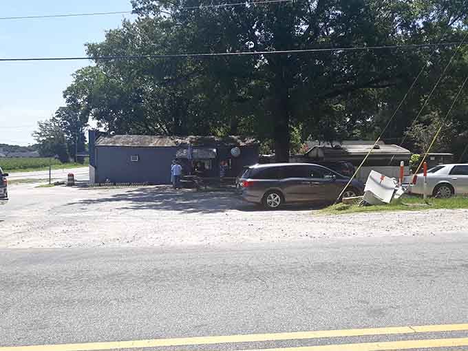 The gravel parking lot and picnic tables tell you everything: this is barbecue stripped down to its smoky soul.