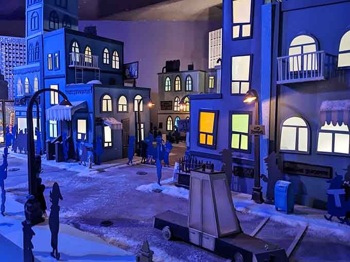 Inside, miniature buildings create an enchanting holiday village that feels like stepping into a snow globe world.
