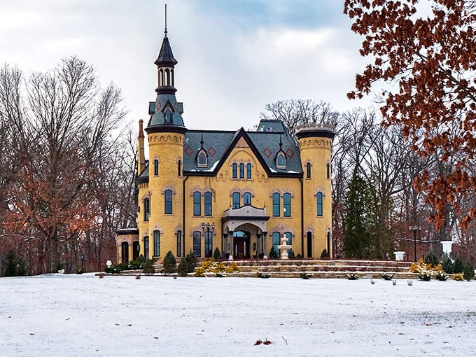 The Dunham Castle glows golden against a winter landscape, its towers and turrets creating a fairytale silhouette.