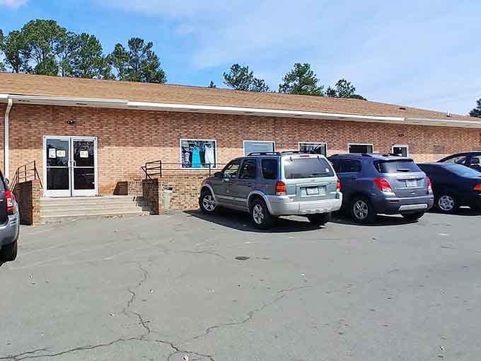 The brick exterior and busy parking lot signal a popular destination where bargain hunters gather daily.
