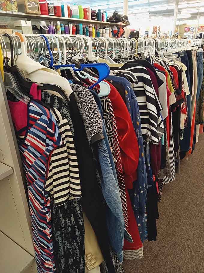 Stripes, solids, and patterns create a rainbow of fashion possibilities hanging neatly on organized racks.