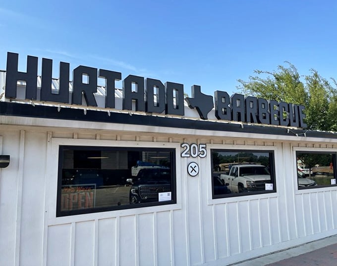 That bold Texas-shaped sign says it all – serious BBQ happens here, no fancy tablecloths required.