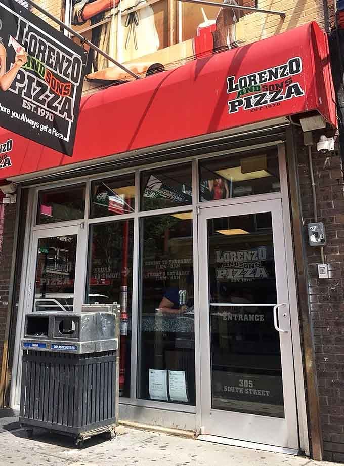 That bold red awning is like a superhero cape—signaling the pizza heroes inside who save hungry Philadelphians daily.