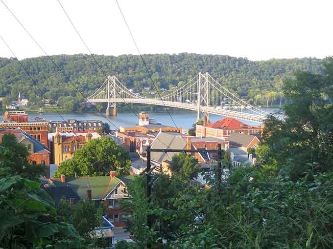 The suspension bridge frames this riverside town like nature's own picture window, absolutely breathtaking from every angle.