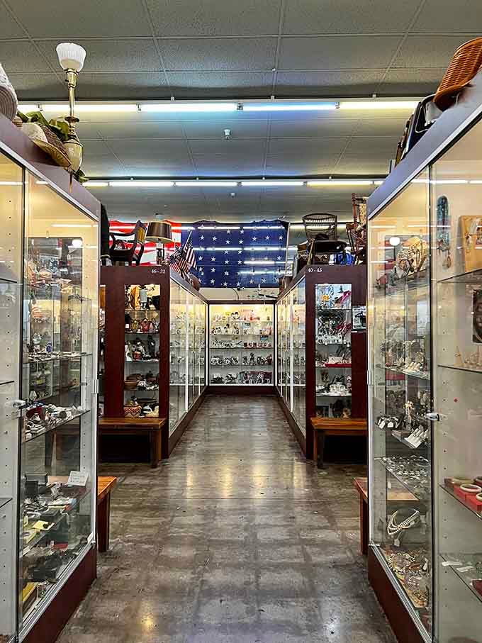 Glass cases filled with treasures line both sides, creating a sparkling corridor of memories and potential discoveries.