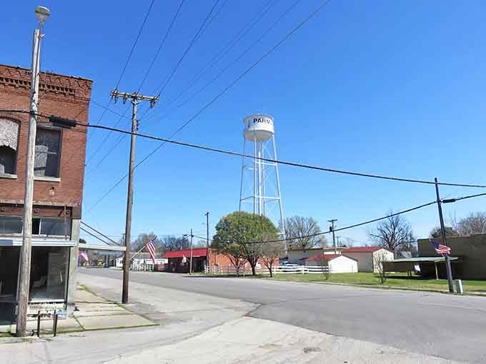 That classic water tower against blue sky reminds you that some towns still believe in keeping things simple and affordable.