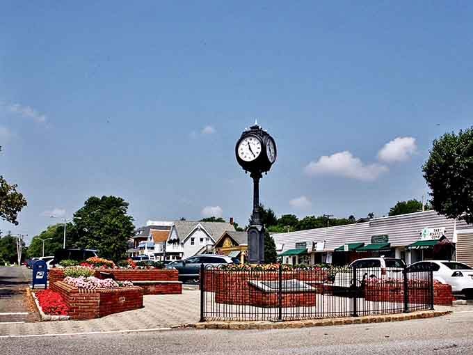 The town clock stands sentinel as residents enjoy their peaceful evening stroll through this perfectly manicured downtown oasis.