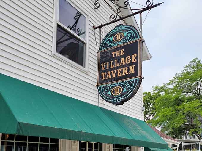 Green awnings and white clapboard siding create a storybook setting where good food meets timeless village atmosphere.