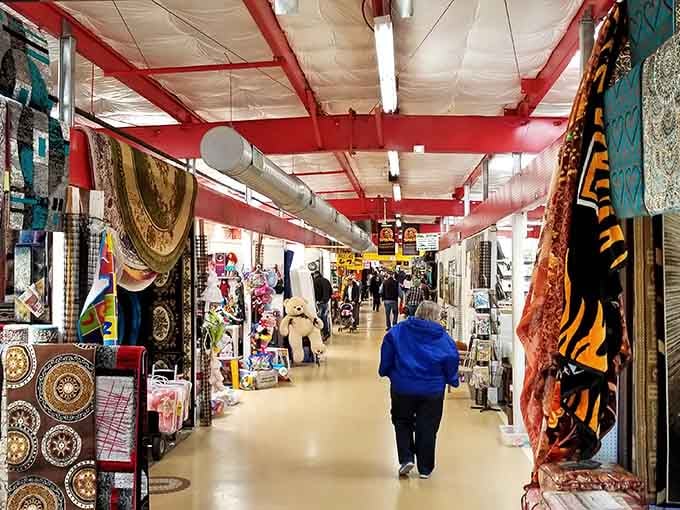 Bold red beams frame the indoor aisles where colorful rugs and textiles create a bazaar-like atmosphere.