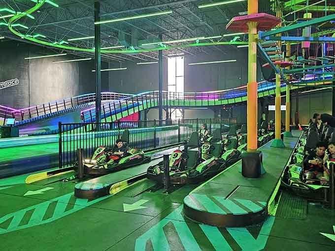 Multi-level tracks wind through the space like a neon-lit roller coaster designed for go-kart enthusiasts.