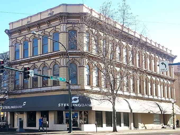 Ornate architectural details crown this vintage building, reminding us that banks once looked like palaces instead of drive-through boxes.