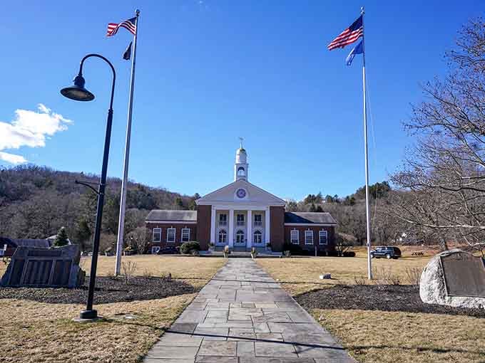 That town hall could double as a movie set—classic New England architecture framed by flags and blue sky.
