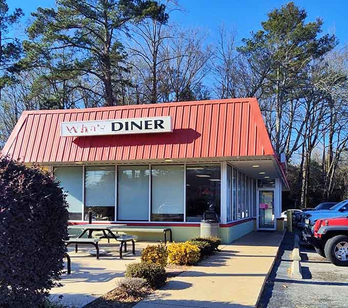 That red metal roof catches your eye from the highway, promising home-cooked comfort food inside.