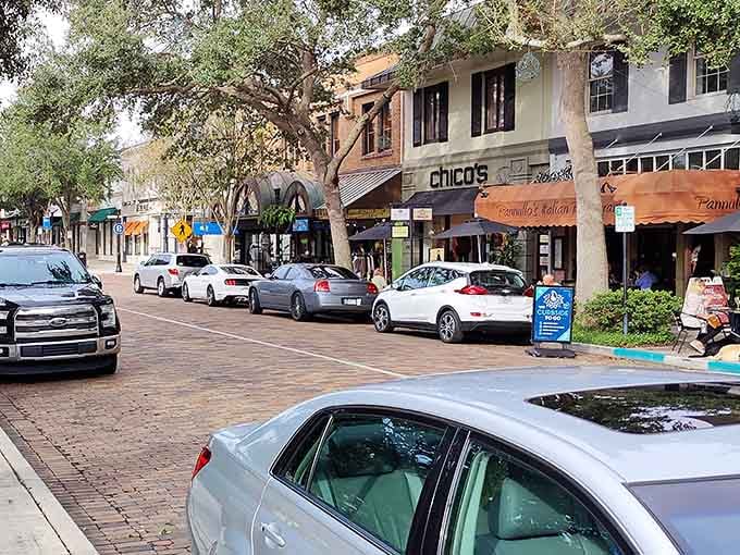 Brick streets and mature oak trees create shade-dappled sidewalks perfect for afternoon strolls and window shopping.