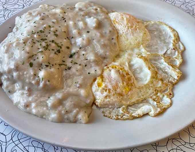 Biscuits drowning in gravy alongside perfectly fried eggs: this is how mornings should always start.