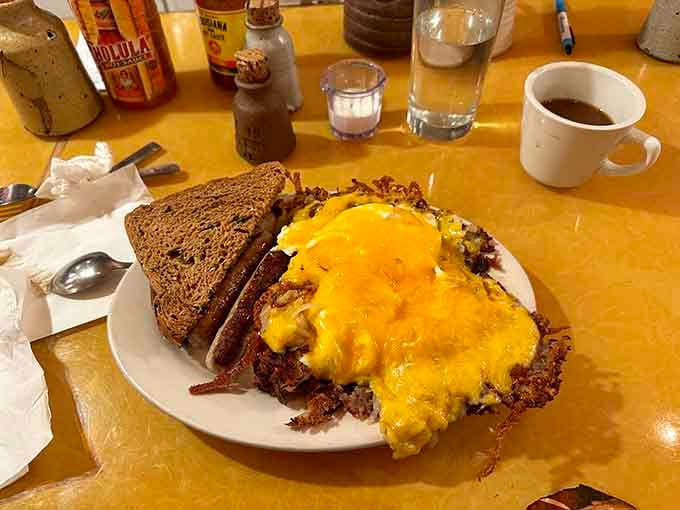 The Jos&eacute; delivers crispy hash browns topped with perfectly scrambled eggs and melted cheese alongside toast and bacon perfection.