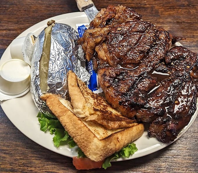 This massive ribeye with a baked potato looks like it could feed a small family or one very happy carnivore.