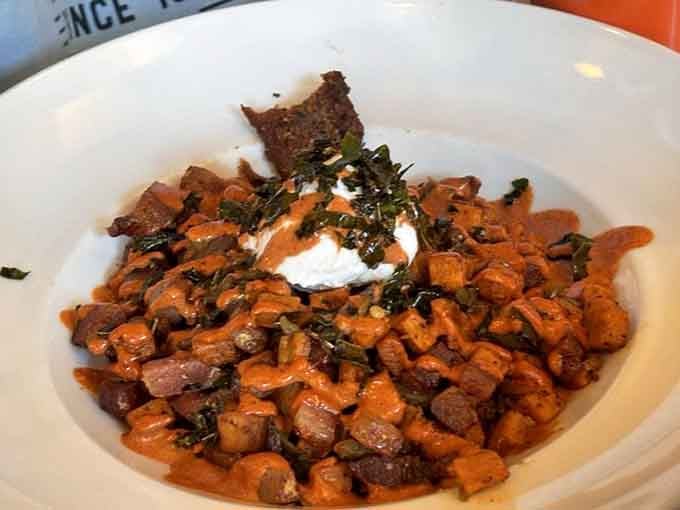 The Bacon Hash arrives looking like someone took everything good about breakfast and put it in one glorious skillet.