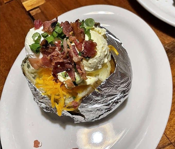 This loaded baked potato isn't just a side dish &ndash; it's practically a work of art, crowned with cheese, bacon, and enough toppings to make a salad bar jealous.