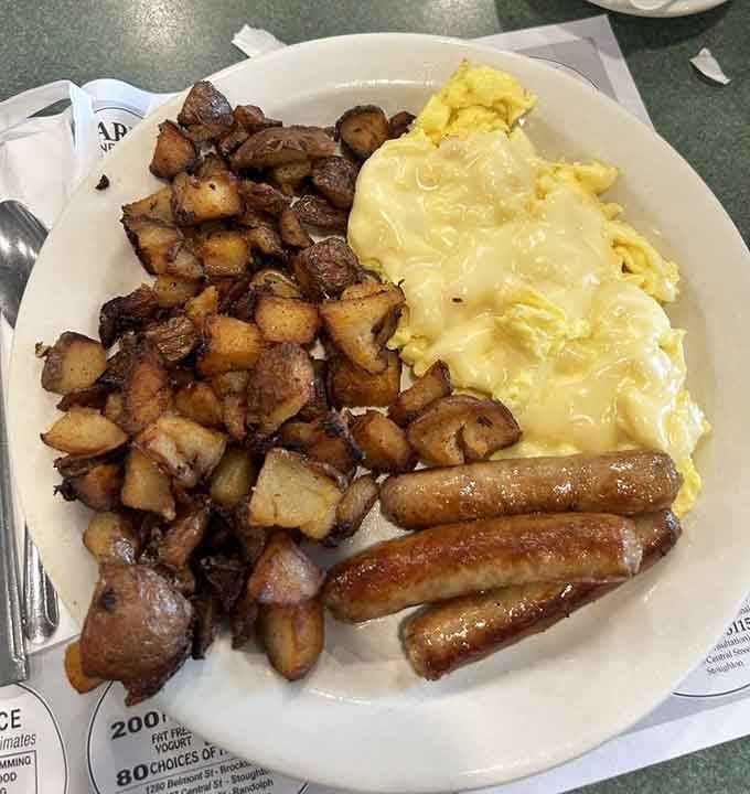 Fluffy scrambled eggs, crispy turkey sausage, and golden home fries create the breakfast trifecta of pure morning happiness.