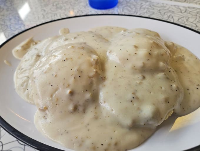 Fluffy biscuits drowning in peppery sausage gravy prove some things in life are worth loosening your belt for, absolutely.