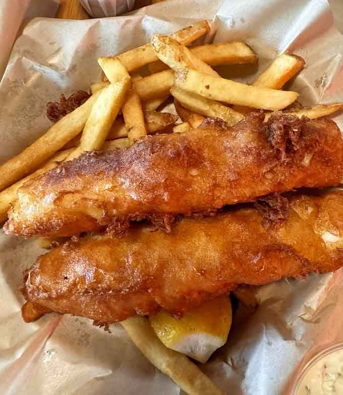 Two pieces of battered fish that could double as flotation devices. This is what "generous" actually means in practice.