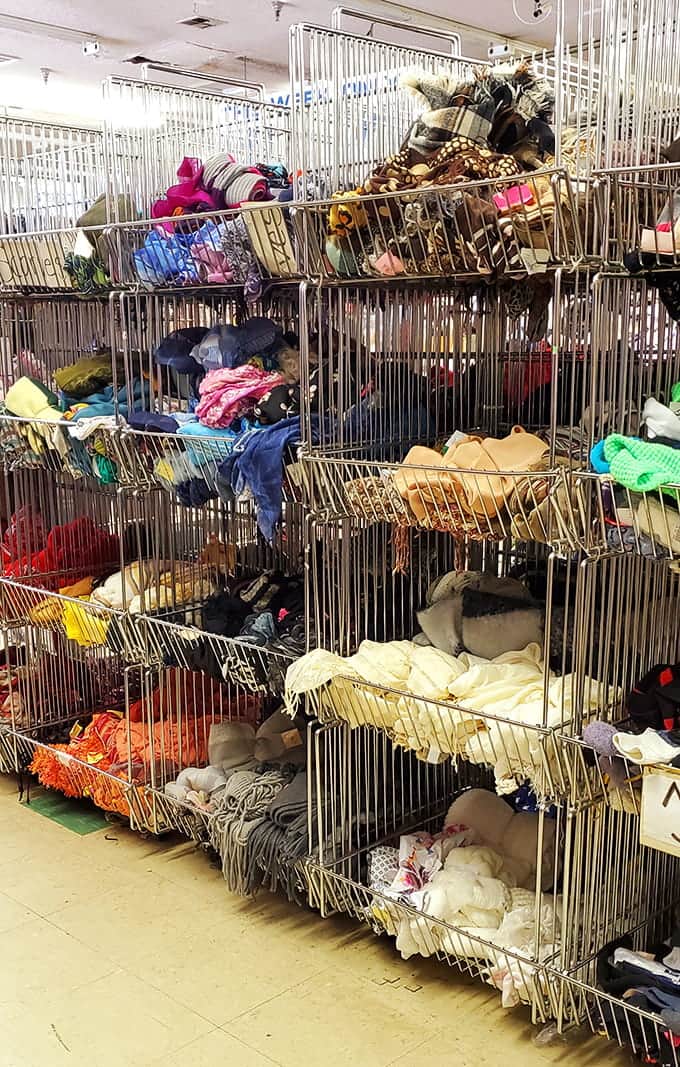 Wire baskets overflowing with scarves and accessories, because sometimes the perfect outfit needs just one more colorful touch.