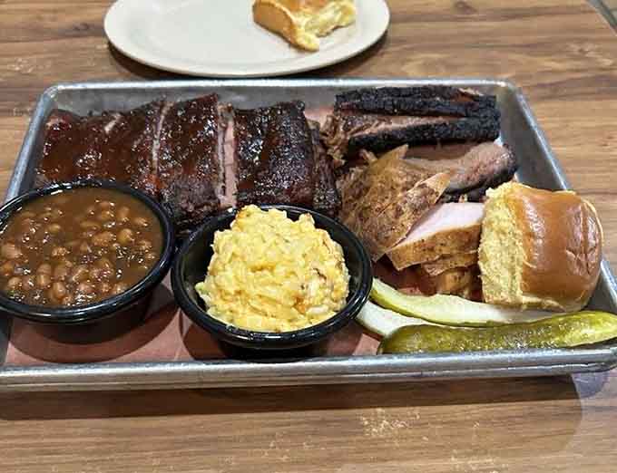 This platter showcases the full barbecue experience: multiple meats, classic sides, and pure Southern comfort on metal.