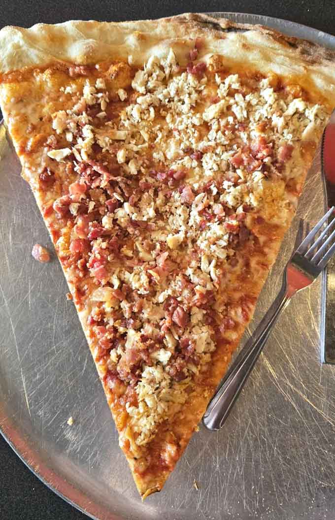 Crumbled toppings blanket this slice like fresh snow, except way more delicious and significantly less cold.