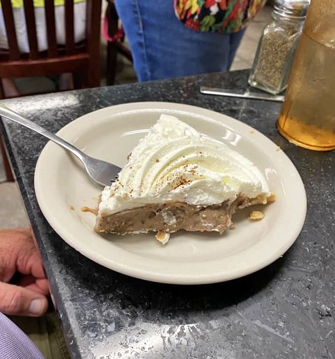 Chocolate pie topped with whipped cream that could make a grown adult weep tears of joy into their coffee cup.