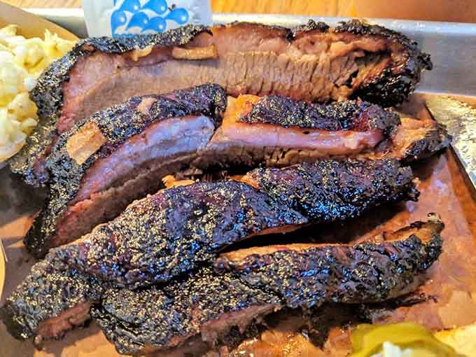 Beef brisket showing off its dark, crusty bark like it just won best-dressed at the barbecue prom.