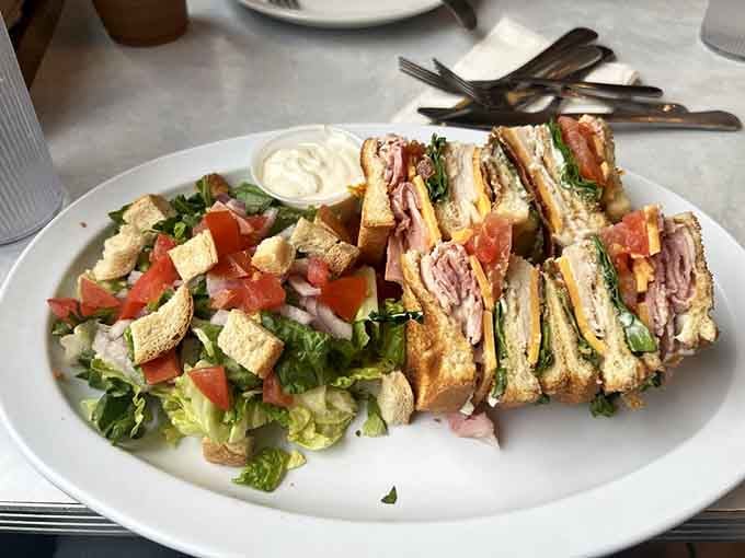 That triple-decker club sandwich towers like a delicious skyscraper you'll happily demolish one floor at a time.