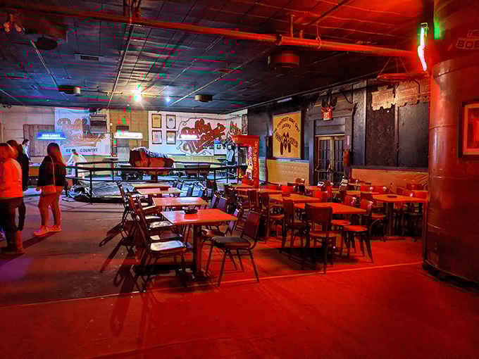 Red lighting transforms the seating area into something atmospheric, perfect for contemplating life's mysteries over cold beer.