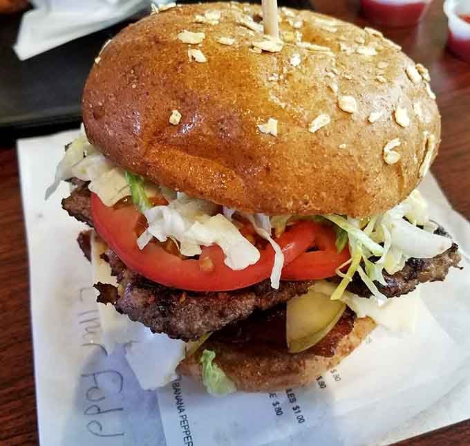 That golden bun holds together a masterpiece of flavors that would make any burger enthusiast weep with joy.